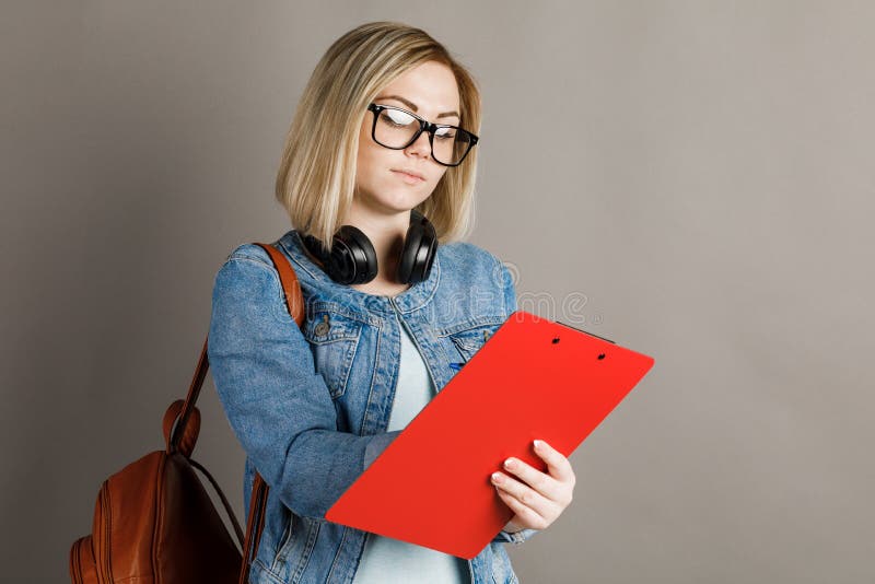 A Student with a Folder for Writing. on a Gray Background. Stock Image ...