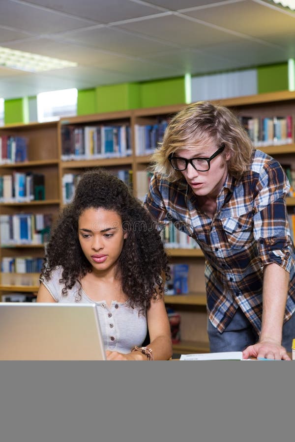 Student Getting Help from Classmate in Library Stock Photo - Image of ...