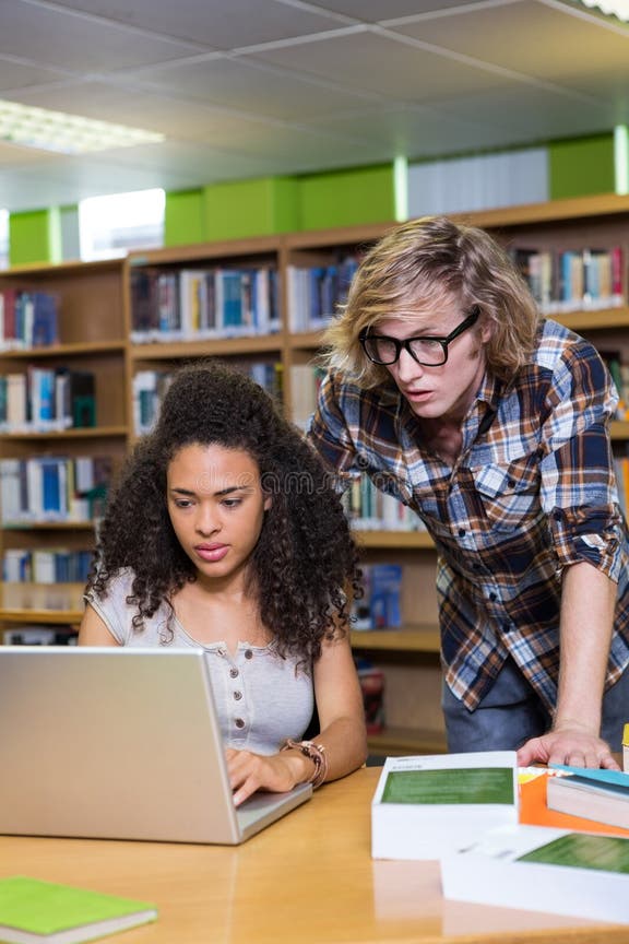 Student Getting Help from Classmate in Library Stock Photo - Image of ...