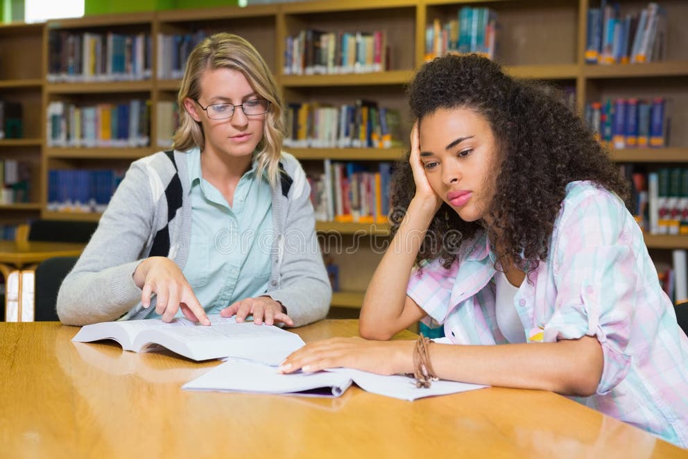 Student Getting Help from Tutor in Library Stock Photo - Image of ...