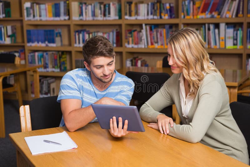 Student Getting Help from Tutor in Library Stock Photo - Image of ...