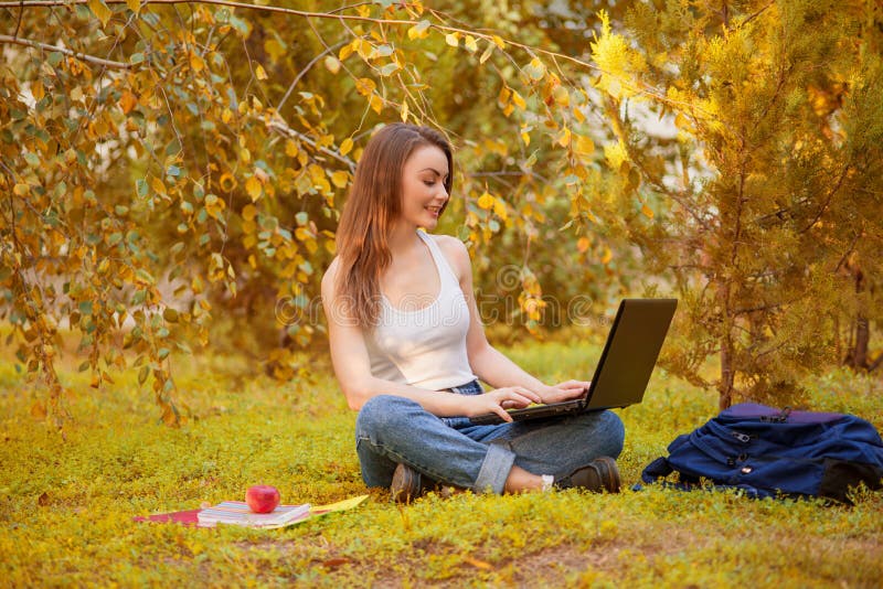 Student Girl on Grass with a Computer Stock Photo - Image of school ...