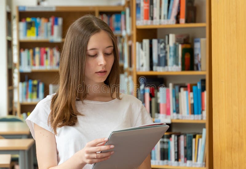 Student girl in a library stock image. Image of caucasian - 146082087