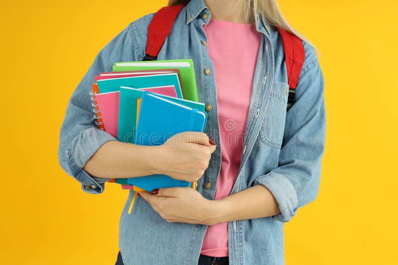 Student Girl with Notebooks on Yellow Background Stock Photo - Image of ...