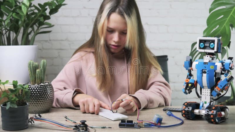 A Student Girl Plugging Cables To Sensor Chips while Learning Arduino Coding and Robotics Stock ...