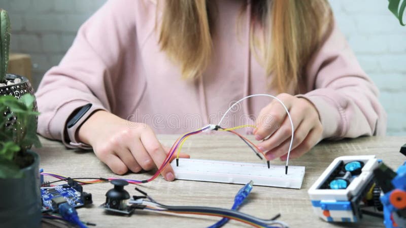 A Student Girl Plugging Cables To Sensor Chips while Learning Arduino Coding and Robotics Stock ...