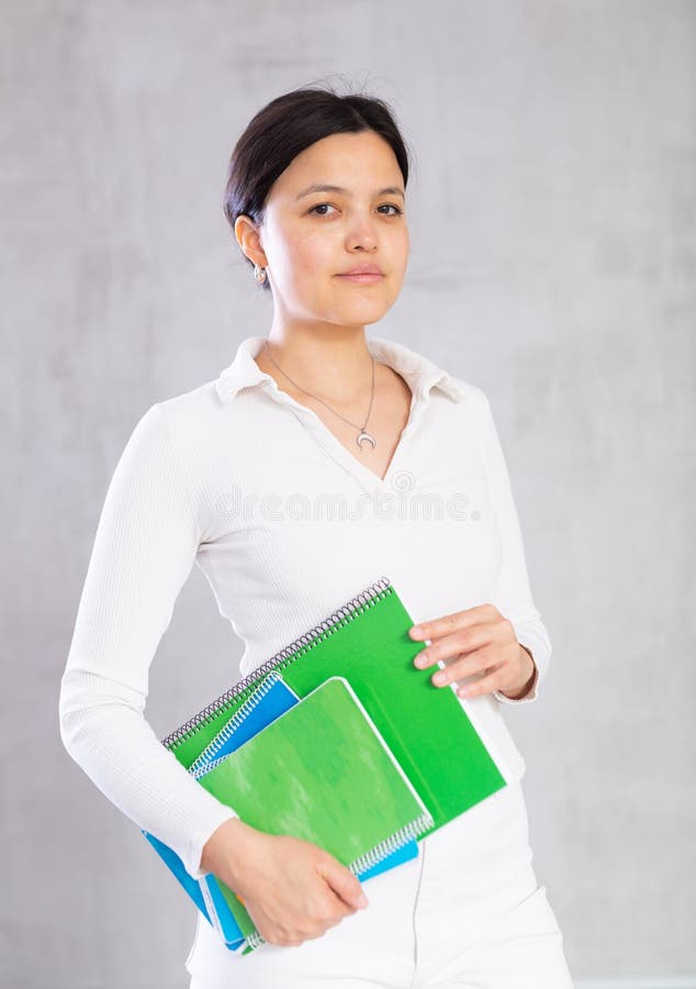 Student Girl with Several Notebooks for Writing Poses in Studio. Stock ...