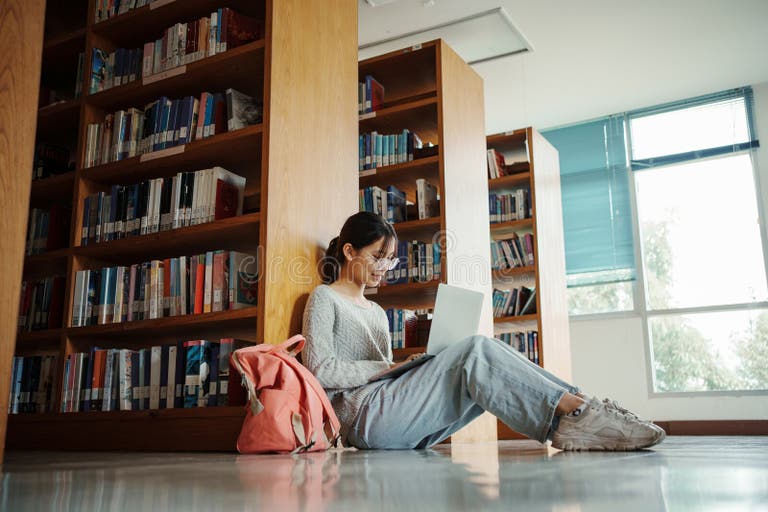 Student Girl Sitting on Floor and Using Laptop, Writes Notes for Paper ...