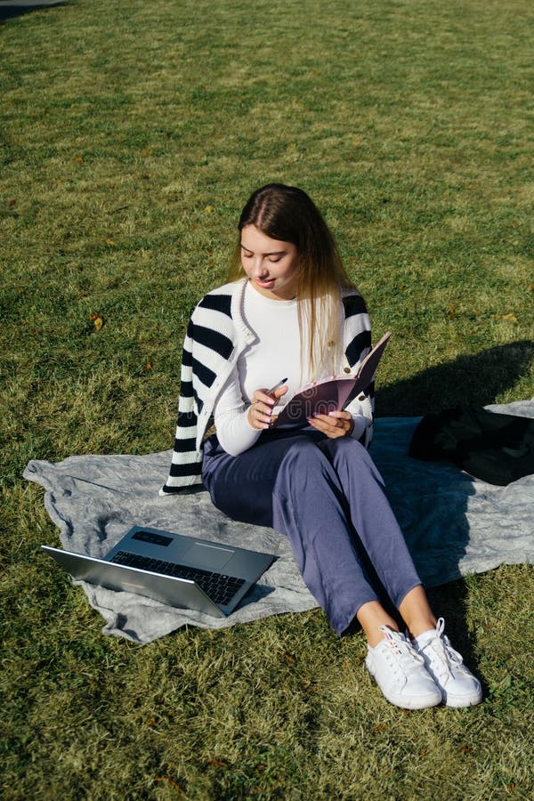 Student Girl is Studying Outside at the Summer Holliday at the ...