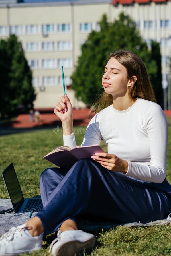 Student Girl is Studying Outside at the Summer Holliday at the ...