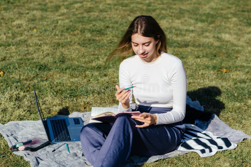 Student Girl is Studying Outside at the Summer Holliday at the ...