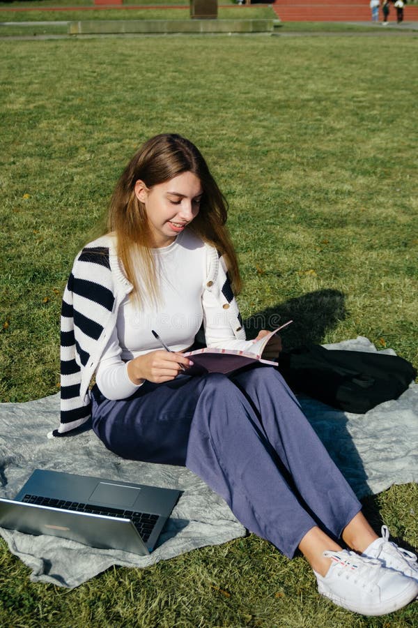 Student Girl is Studying Outside at the Summer Holliday at the ...
