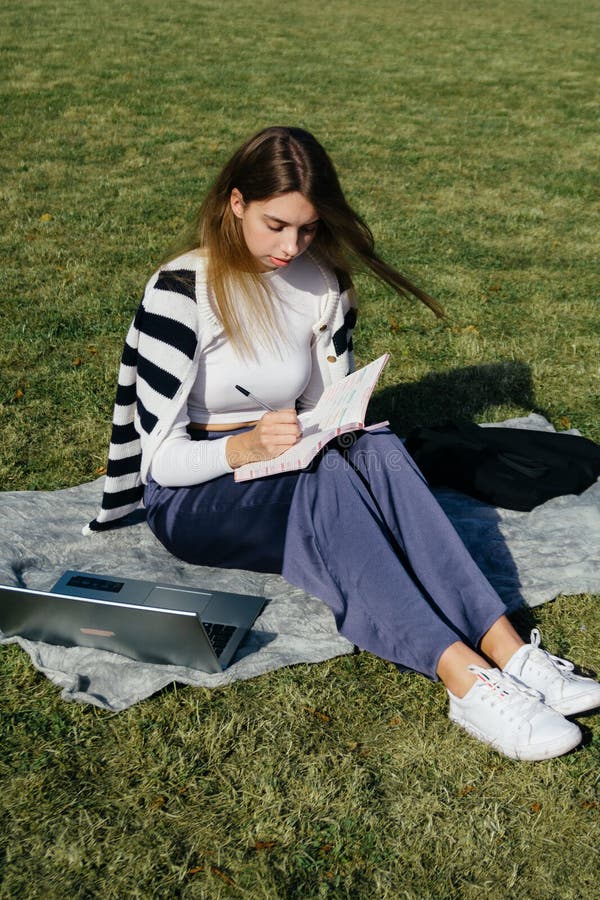 Student Girl is Studying Outside at the Summer Holliday at the ...