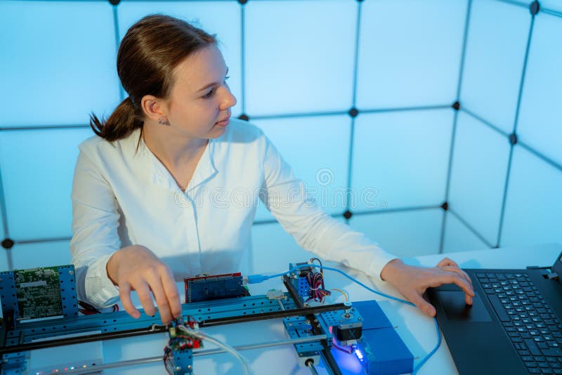 Student Girl in the University Automation Laboratory Sets Up a Model of ...