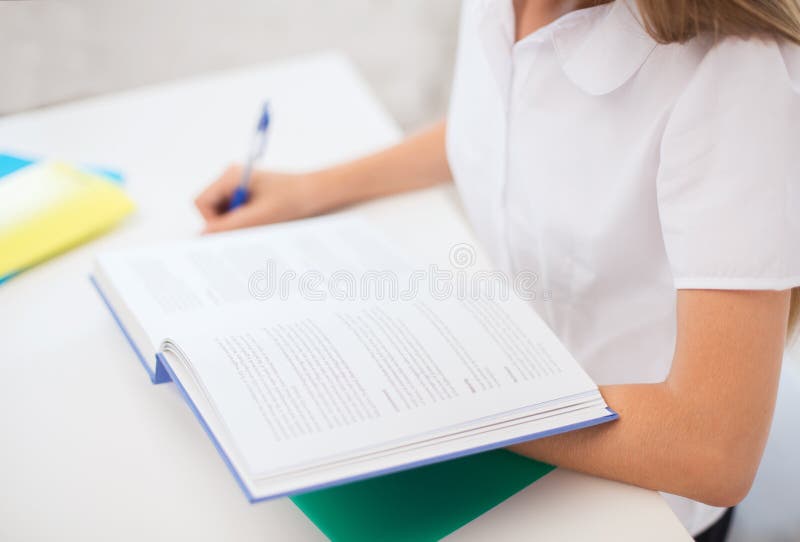 Student Girl Writing in Notebook at School Stock Image - Image of ...