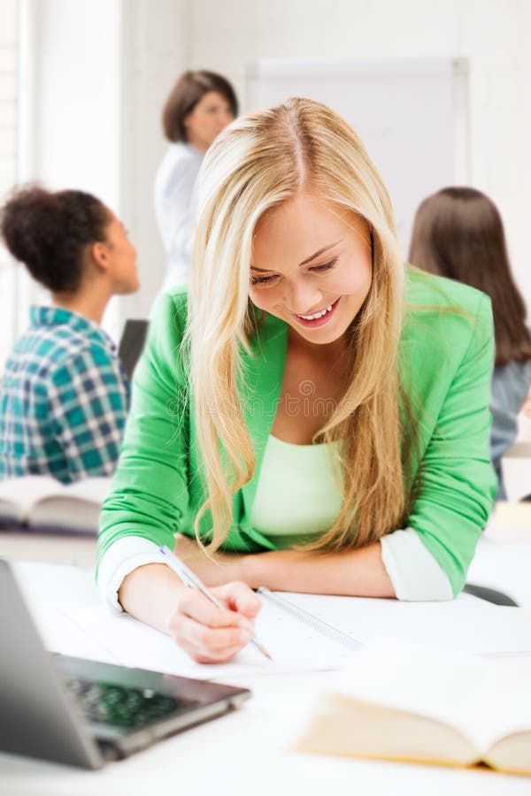 Student Girl Writing in Notebook at School Stock Image - Image of ...