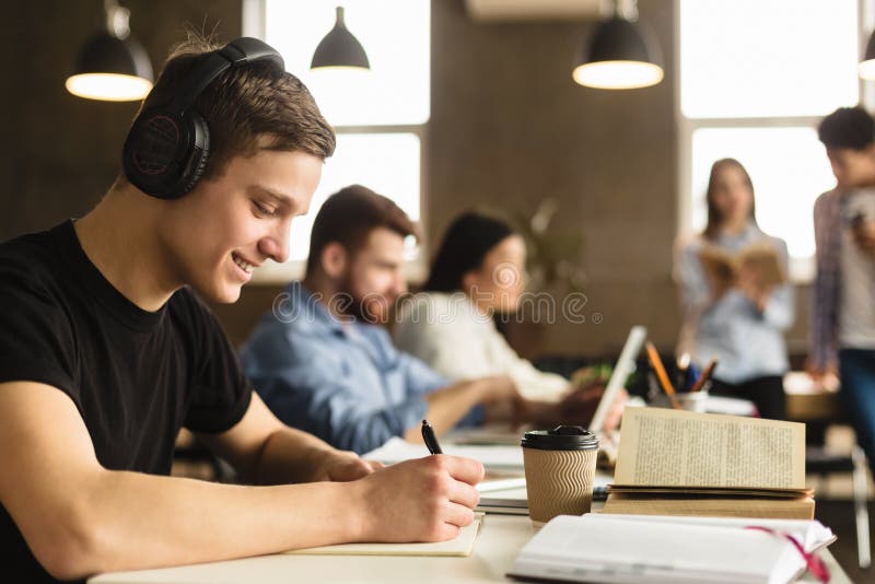 Student Guy Preparing for Classes, Taking Notes in Library Stock Image ...