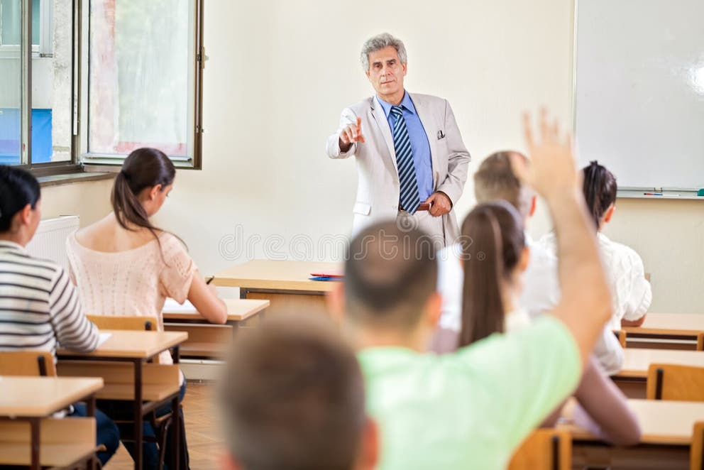 Student with Hand Up in Class Stock Image - Image of male, pointing ...