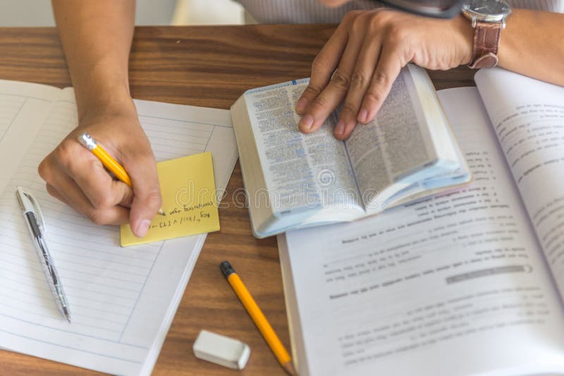 Student Hands Taking Note and Looking Up Dictionary Stock Photo - Image ...