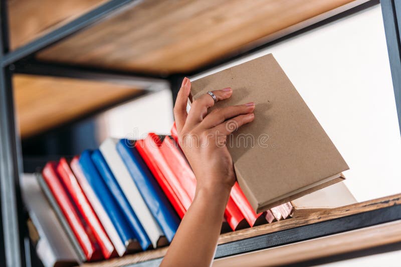 Student Holding Book at Bookshelf in Library Stock Image - Image of ...