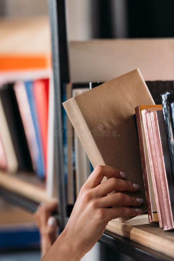 Student Holding Book at Bookshelf in Library Stock Image - Image of ...