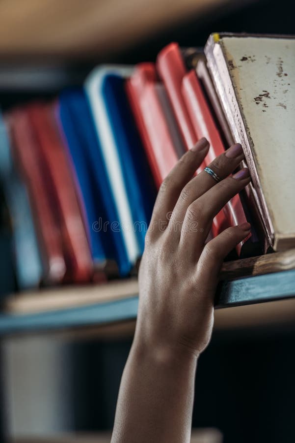 Student Holding Book at Bookshelf in Library Stock Image - Image of ...