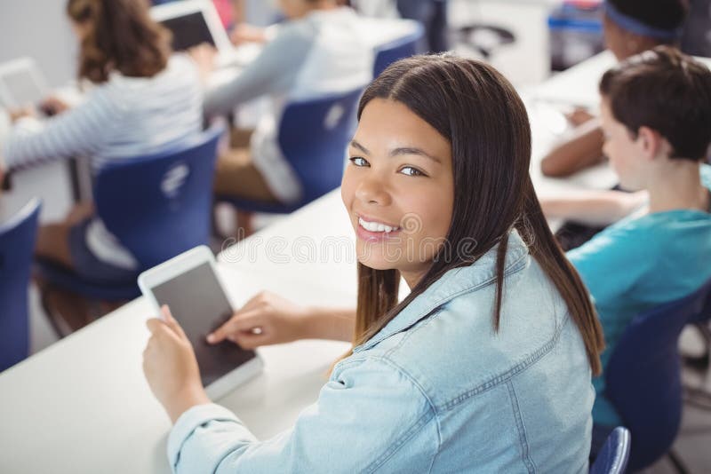 Student Holding Digital Tablet in Classroom Stock Photo - Image of male ...