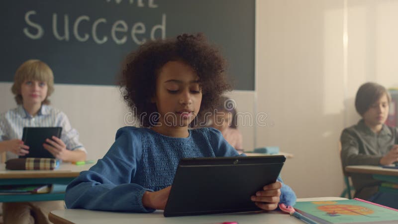 Student Holding Digital Tablet in Classroom. Schoolgirl Using Tablet ...