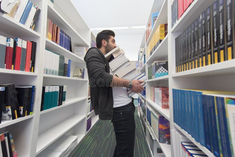 Student Holding Lot of Books in School Library Stock Image - Image of ...