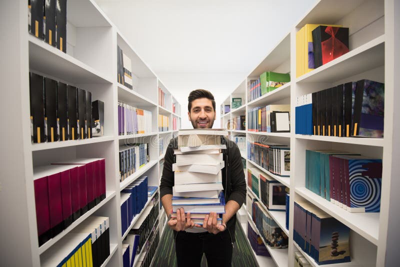 Student Holding Lot of Books in School Library Stock Photo - Image of ...