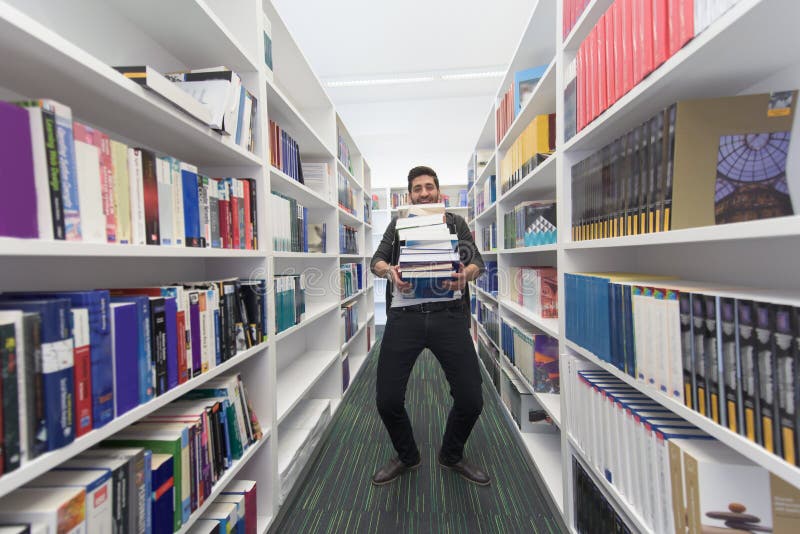 Student Holding Lot of Books in School Library Stock Photo - Image of ...
