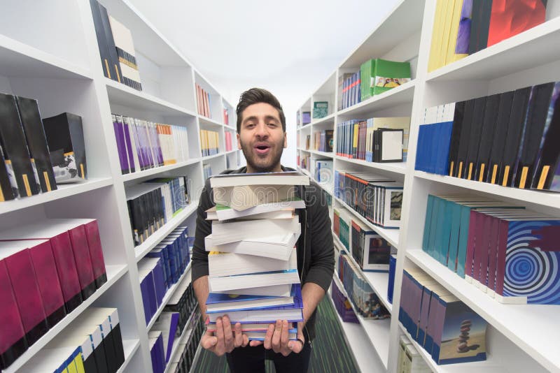 Student Holding Lot of Books in School Library Stock Photo - Image of ...