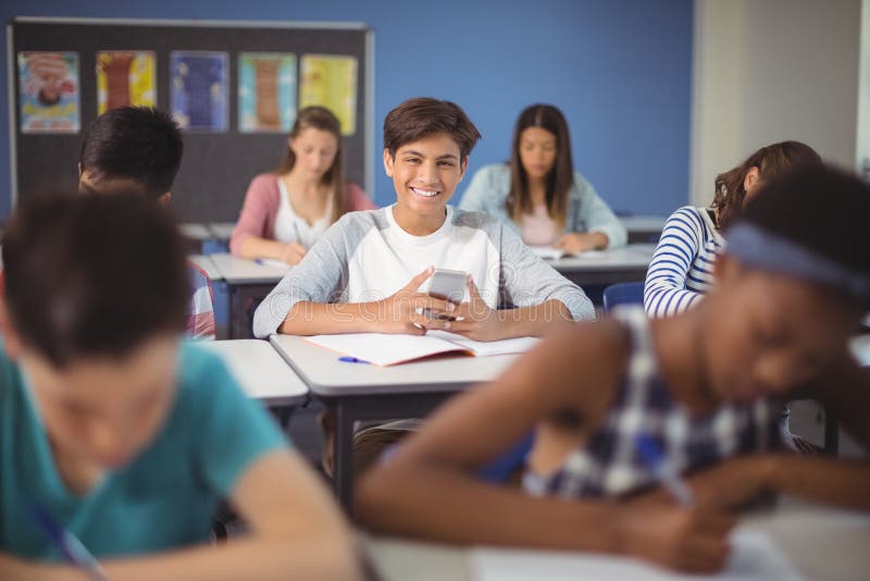Student Holding Mobile Phone in Classroom Stock Image - Image of male ...