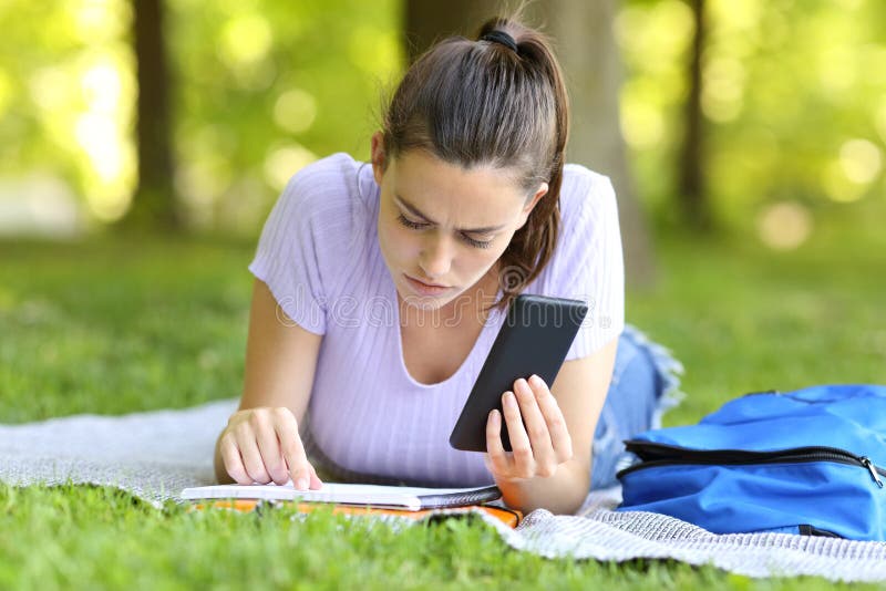 Student Holding Phone Checking Notes Studying in a Campus Stock Image ...
