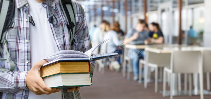 Student Holding a Stack of Textbooks in Front of a Cafe Stock Image ...