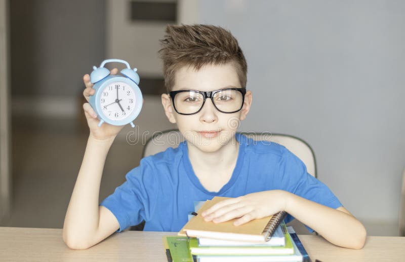 The Student Holds an Alarm Clock in His Hands. Stock Image - Image of ...