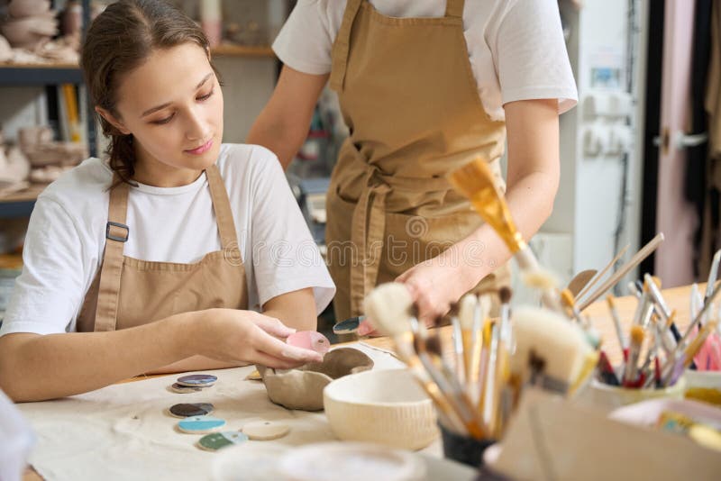 Student Holds Sample of Paint for Clay Products in Her Hands Stock ...