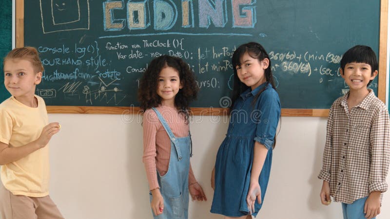 Smart Student Looking at Camera while Standing in Front of Blackboard ... Smart Student Looking at Camera while Standing in Front of Blackboard ...