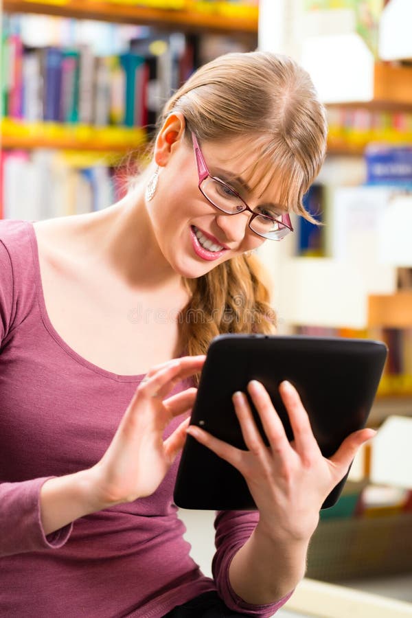 Closeup of Student Using Digital Tablet in Library Stock Photo - Image ...