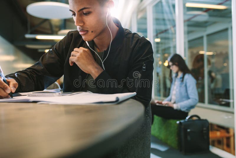 Student at the Library Listen To Music and Making Notes Stock Photo ...