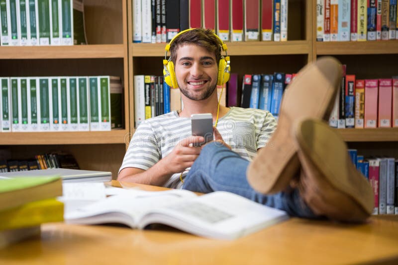 Student Listening Music in the Library with Smartphone Stock Image ...