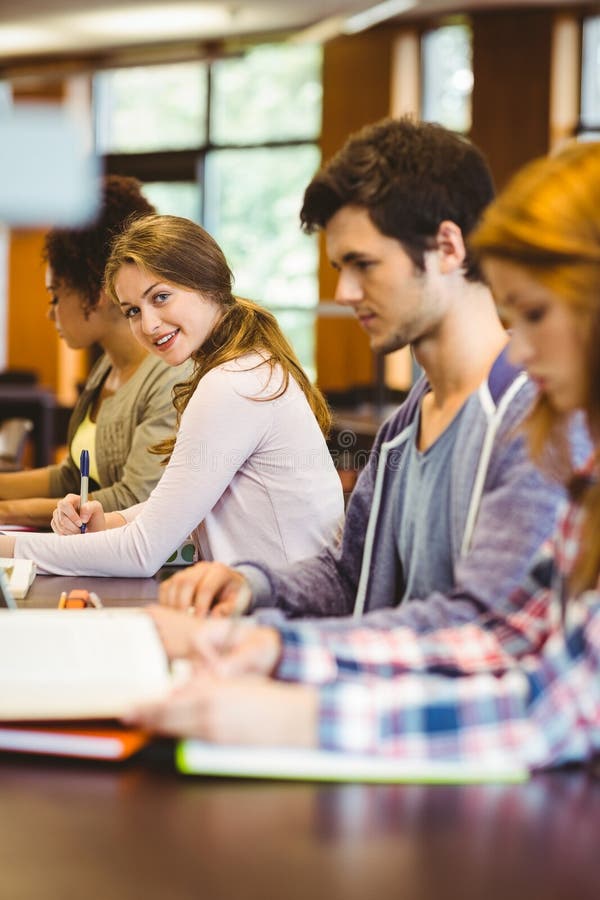 Student Looking at Camera while Studying with Classmates Stock Image ...
