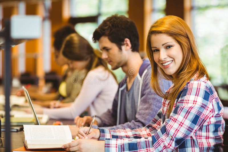 Student Looking at Camera while Studying with Classmates Stock Image ...