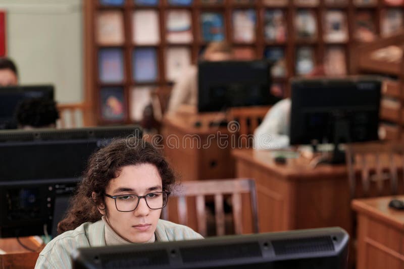 Student Looking at Computer Screen with Blurred Background Stock Image ...