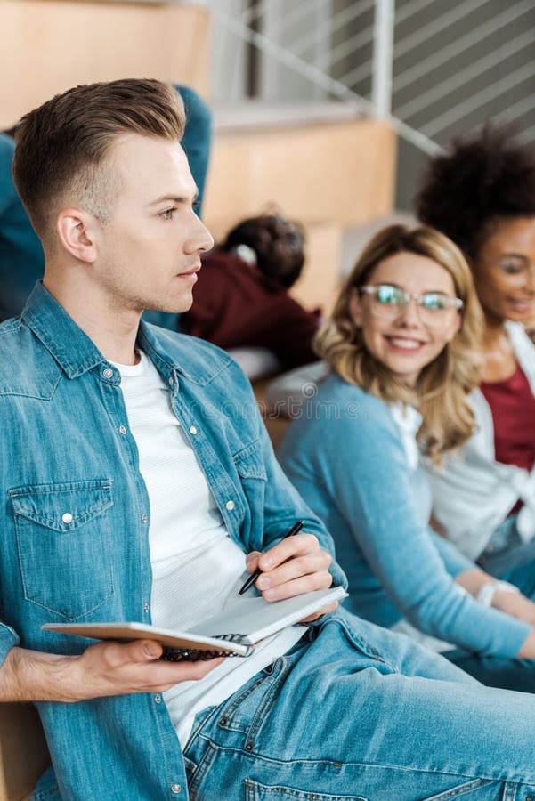 Student with Notebook Sitting with Friends Stock Image - Image of ...