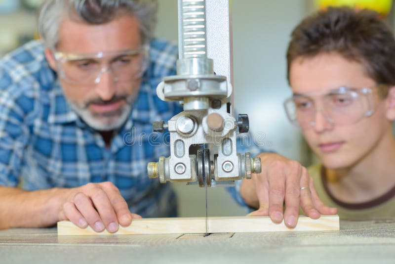 Student Observing Teacher Sawing Wood Stock Photo - Image of craft ...