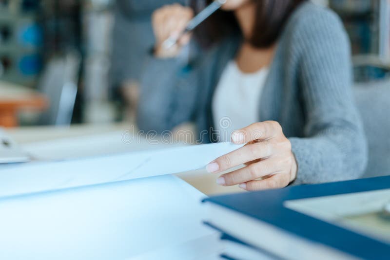Student Open a Book and Read for Exam in the Library. Education Concept ...