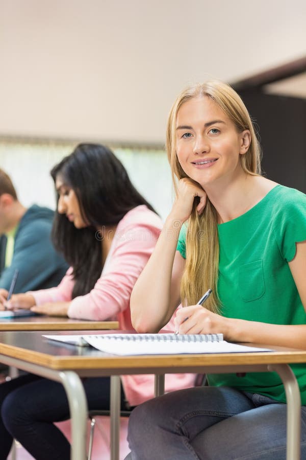 Student with Others Writing Notes in Classroom Stock Photo - Image of ...