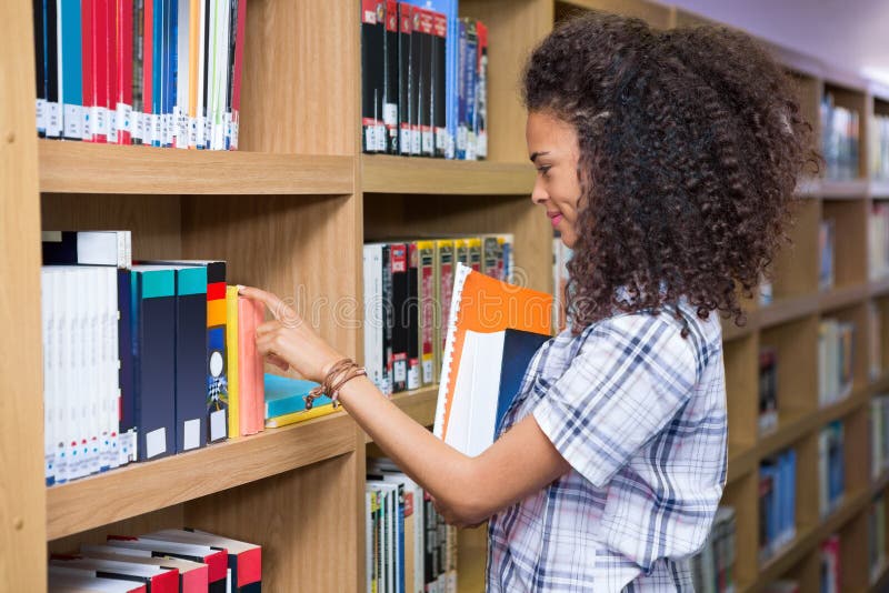 Student Picking a Book from Shelf in Library Stock Photo - Image of ...