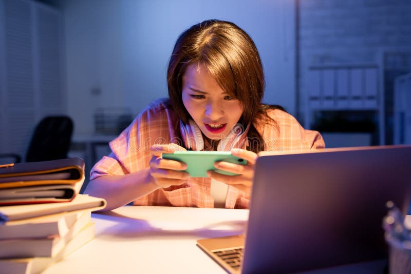 Student play game on phone stock image. Image of people - 151085177